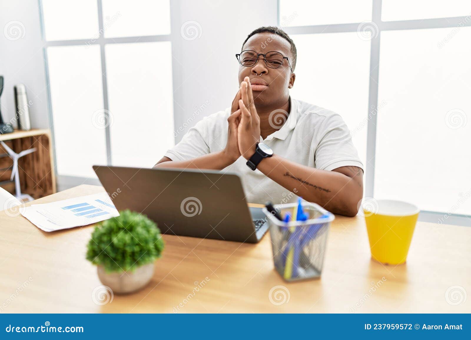 Young African Man Working at the Office Using Computer Laptop Begging ...