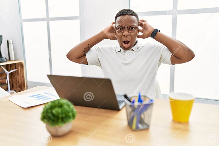 Young African Man Working at the Office Using Computer Laptop Crazy and ...