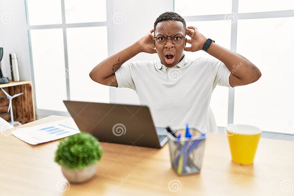 Young African Man Working at the Office Using Computer Laptop Crazy and ...