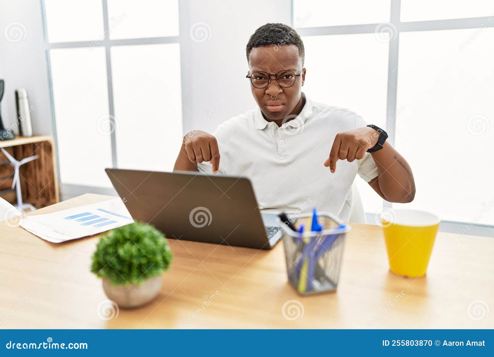 Young African Man Working at the Office Using Computer Laptop Pointing ...