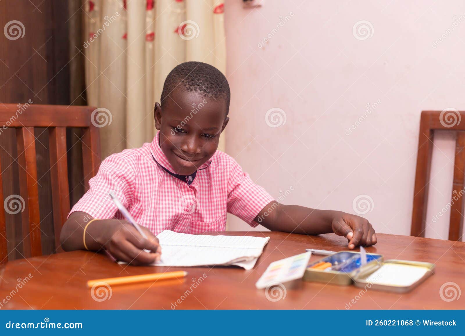 Young African Schoolboy Focused Smiling Writing on Paper Stock Photo ...