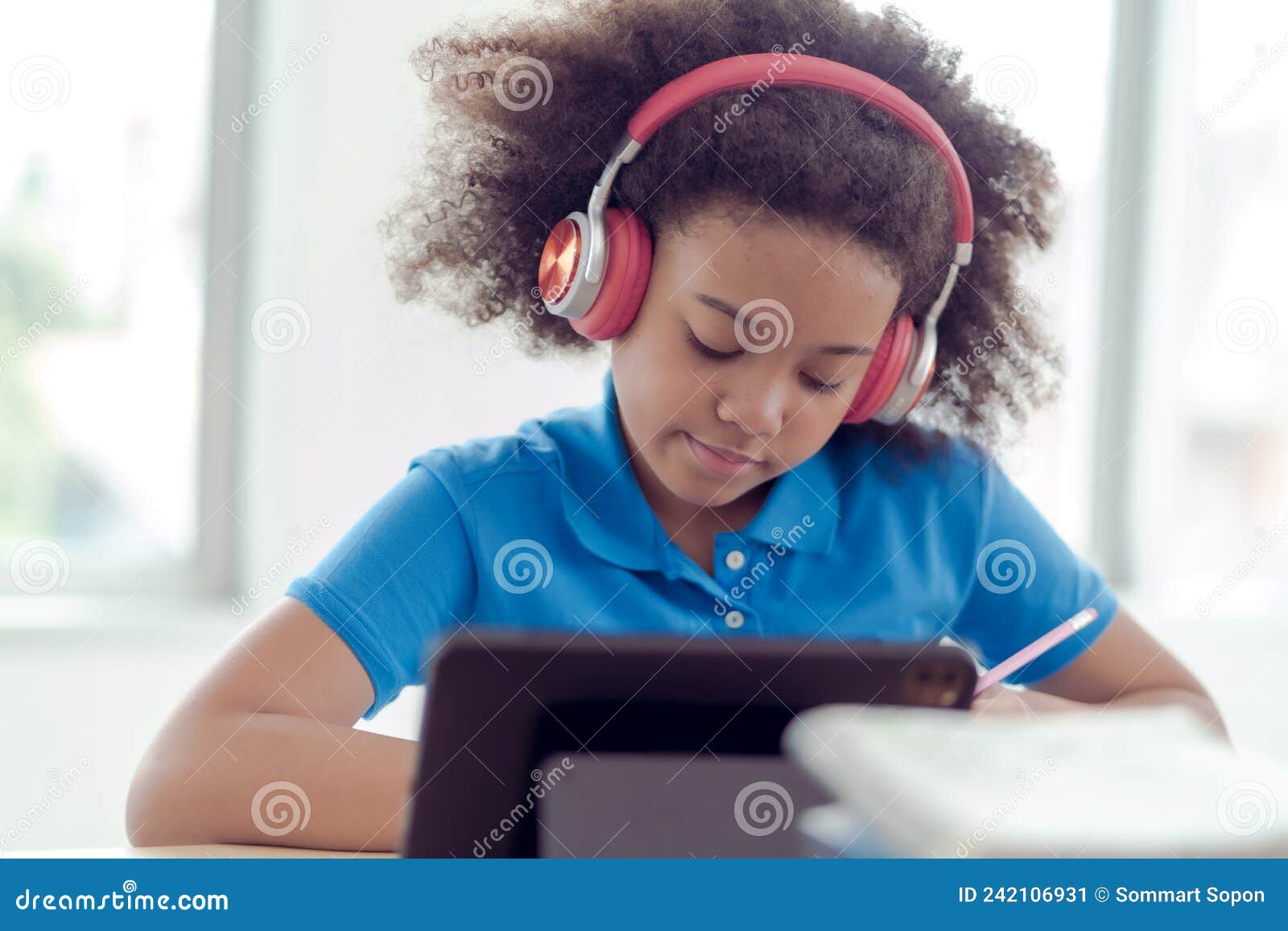 Young African Students Wearing Headphones To Study Online Using a ...