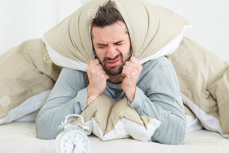 Young angry man waking up stock image. Image of suffer - 165454835