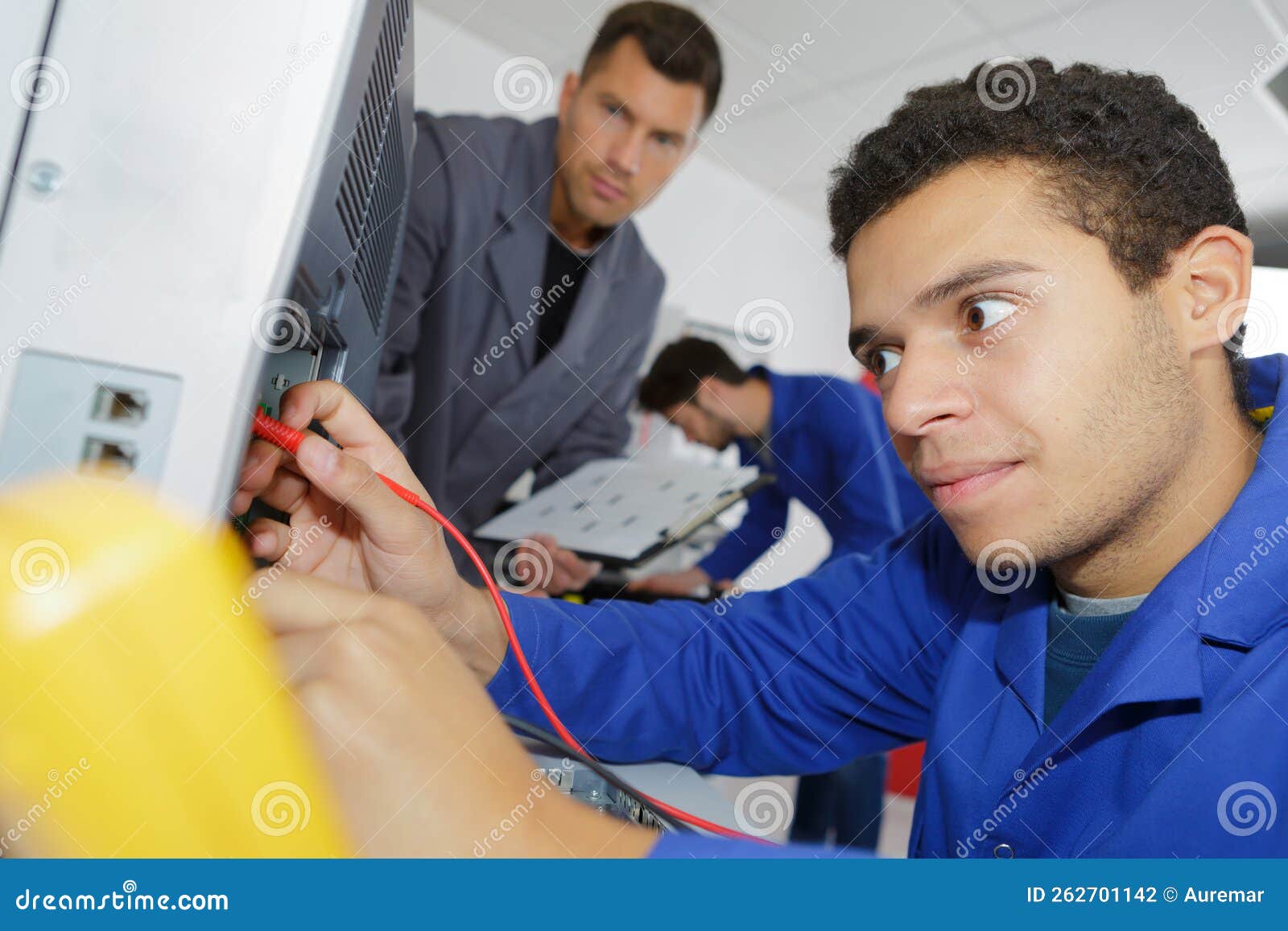 Young Apprentice Electrician Testing Appliance with Multimeter Stock ...