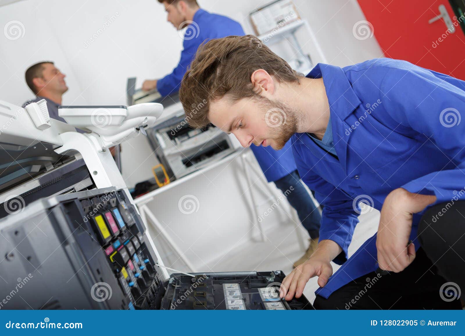 Young Apprentice with Screwdriver in Hand Fixing Printer Stock Image ...