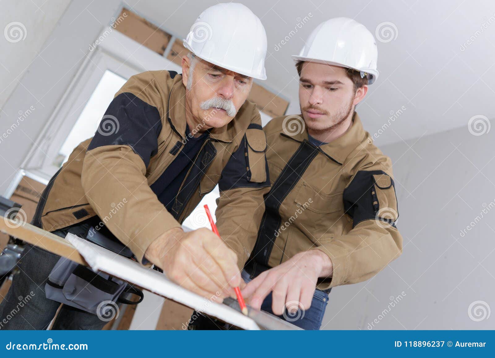 Young Apprentice and Senior Mason Stock Image - Image of background ...