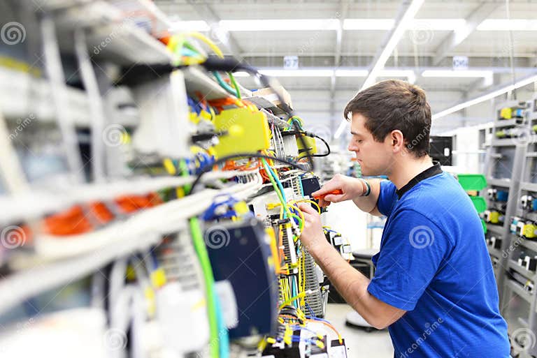 Young Apprentice Worker in an Industrial Company Assembling Electronic ...
