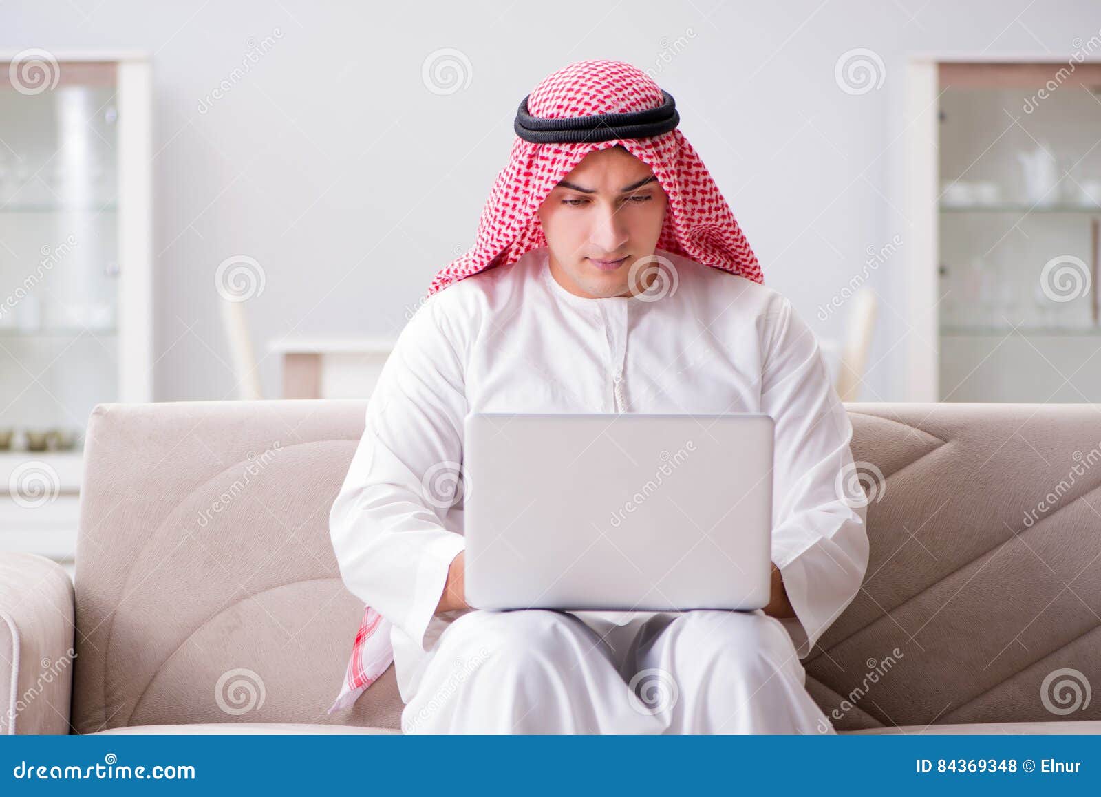 The Young Arab Businessman Working with Laptop on Sofa Stock Photo ...