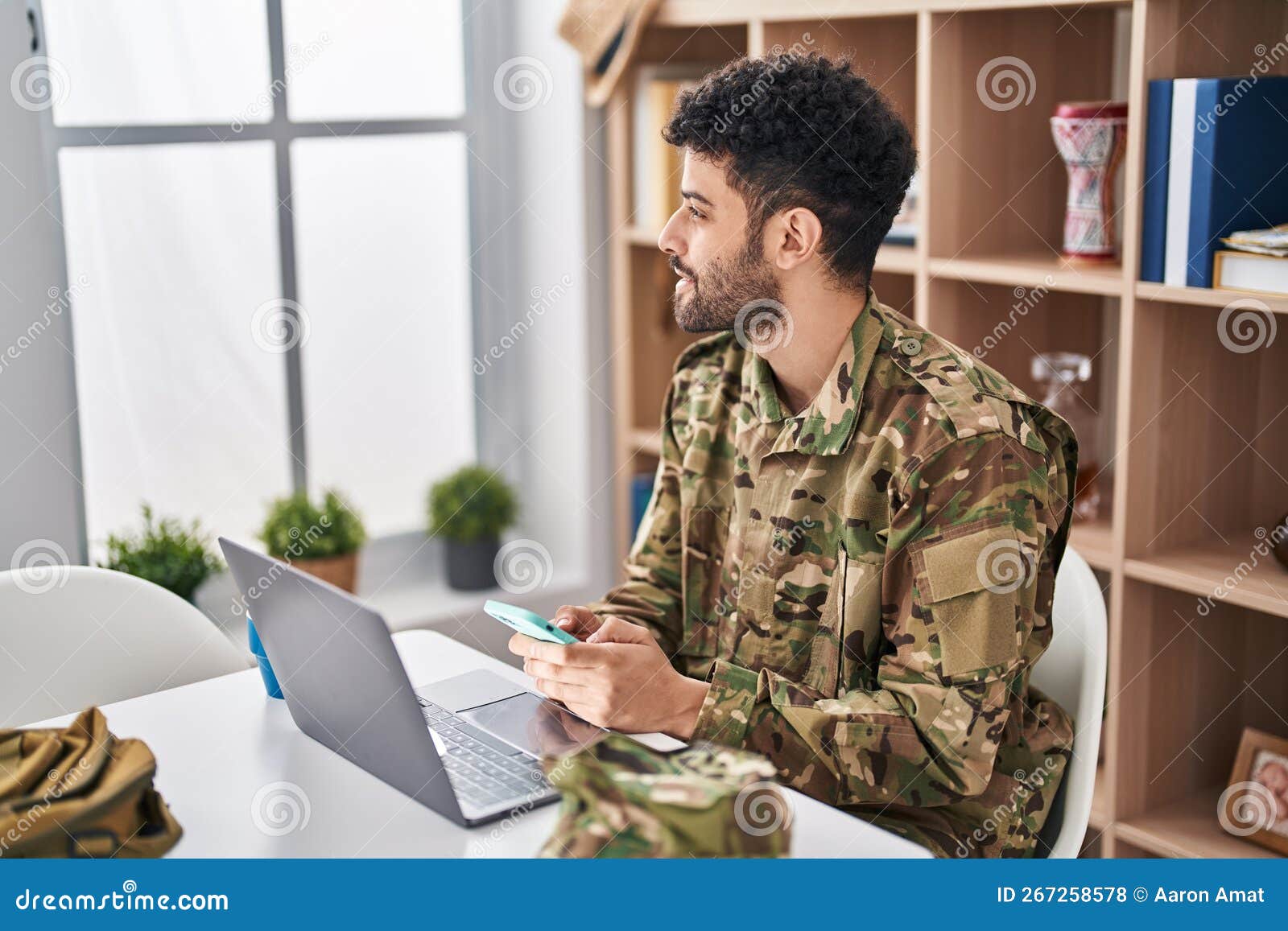 Young Arab Man Army Soldier Using Laptop Using Smartphone at Home Stock ...