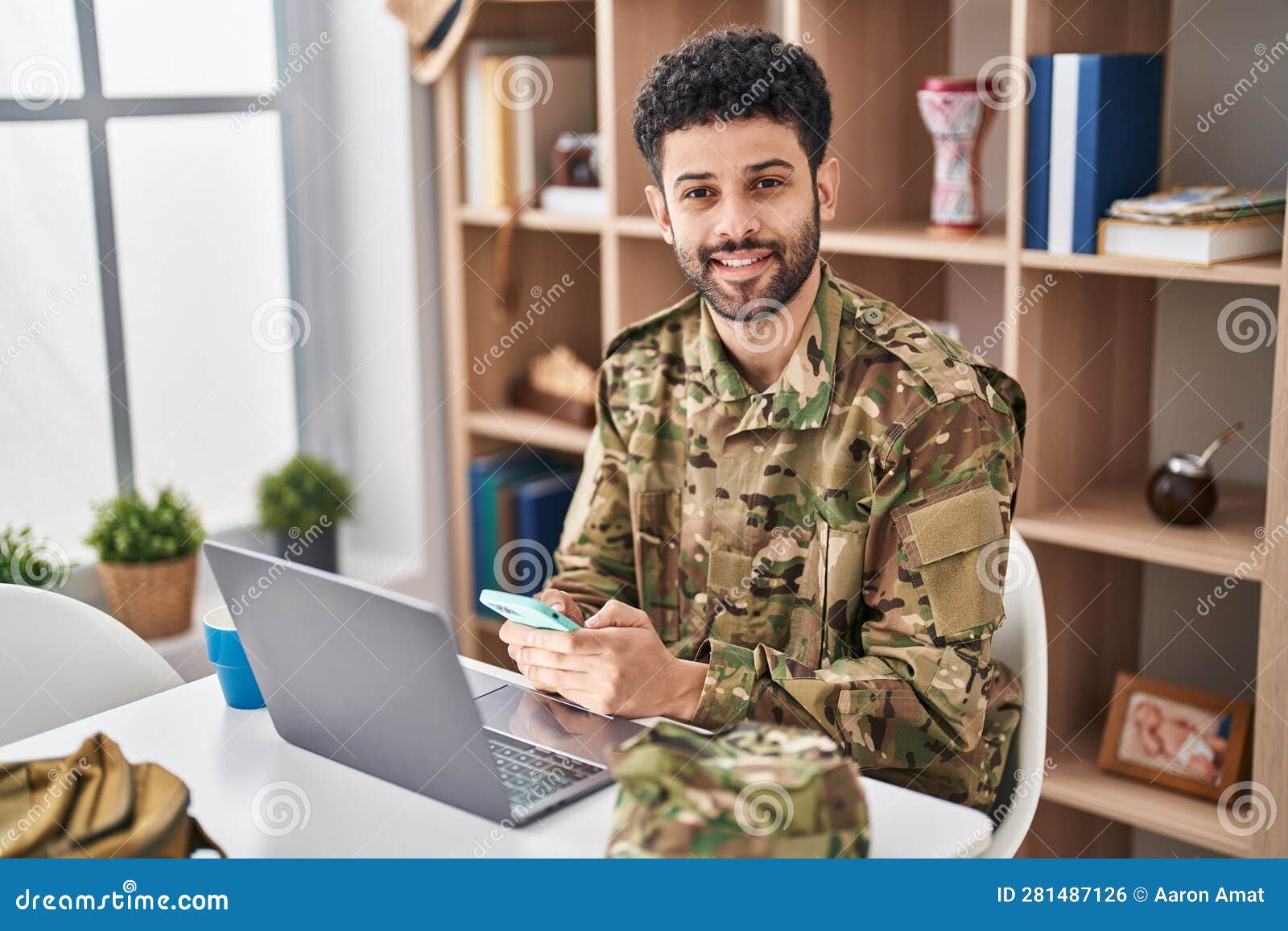 Young Arab Man Army Soldier Using Laptop Using Smartphone at Home Stock ...