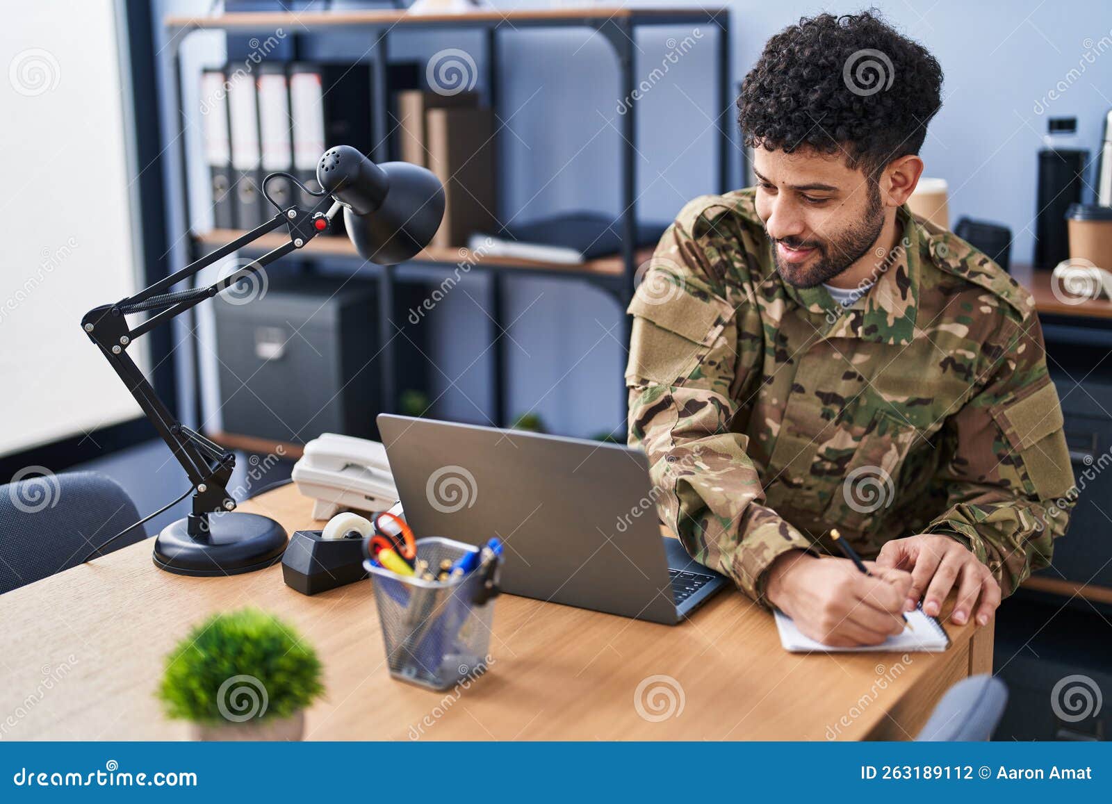 Young Arab Man Army Soldier Using Laptop Writing on Notebook at Office ...