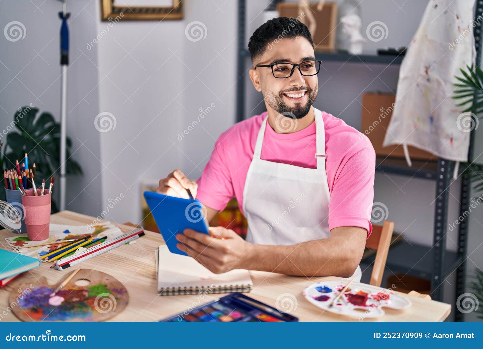 Young Arab Man Artist Drawing on Notebook Using Touchpad at Art Studio ...