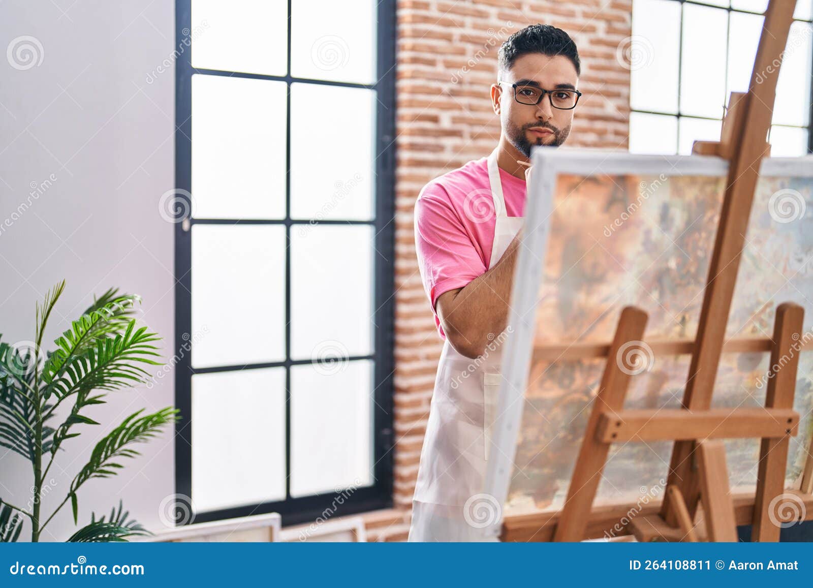 Young Arab Man Artist Looking Draw with Doubt Expression at Art Studio ...