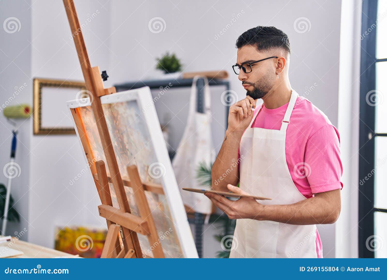 Young Arab Man Artist Looking Draw with Doubt Expression at Art Studio ...