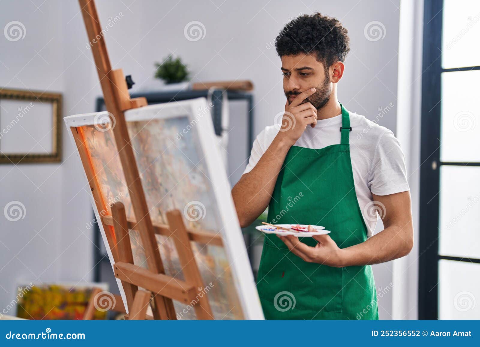 Young Arab Man Artist Looking Drawi with Doubt Expression at Art Studio ...