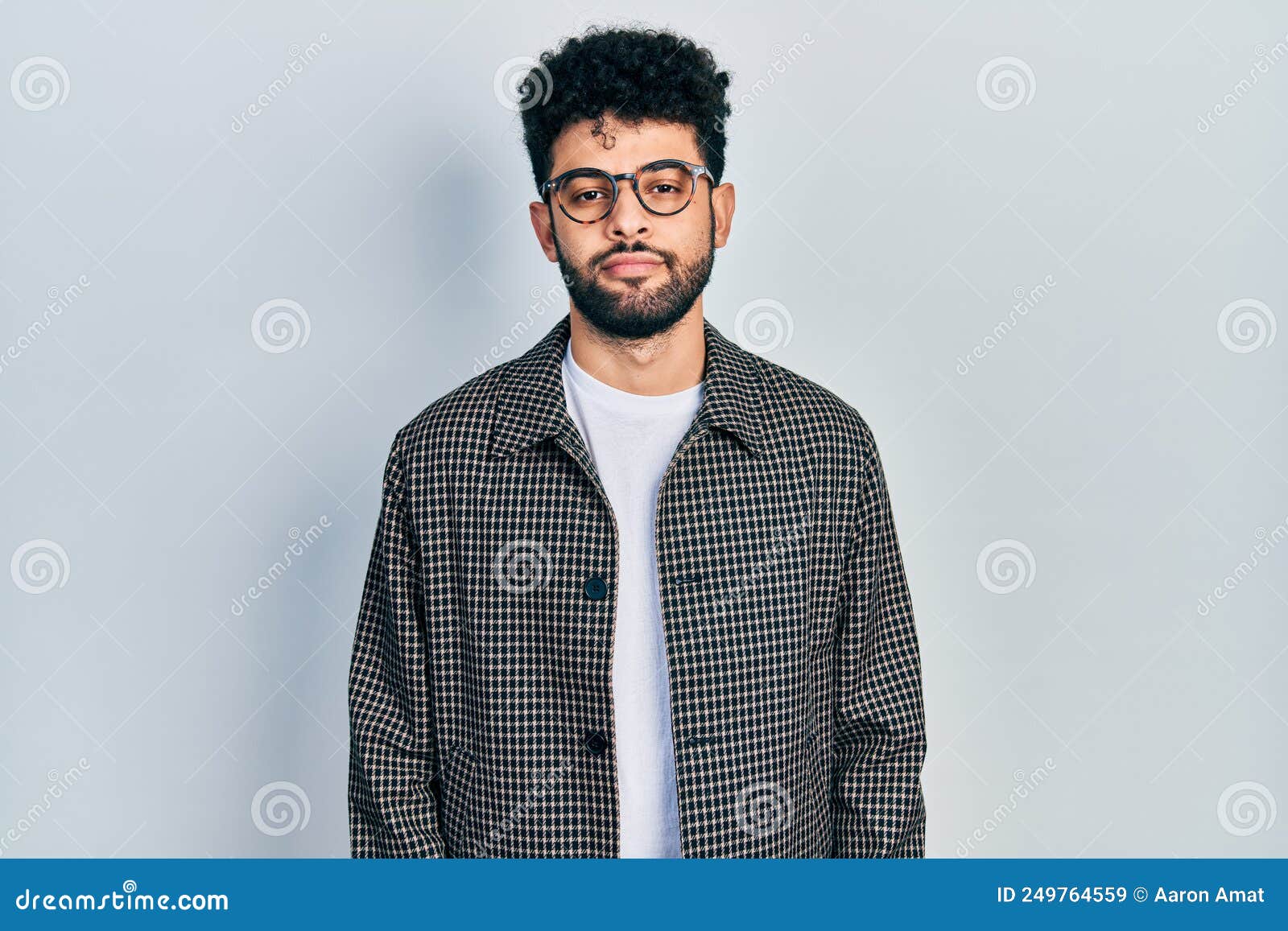 Young Arab Man With Beard Wearing Glasses Relaxed With Serious