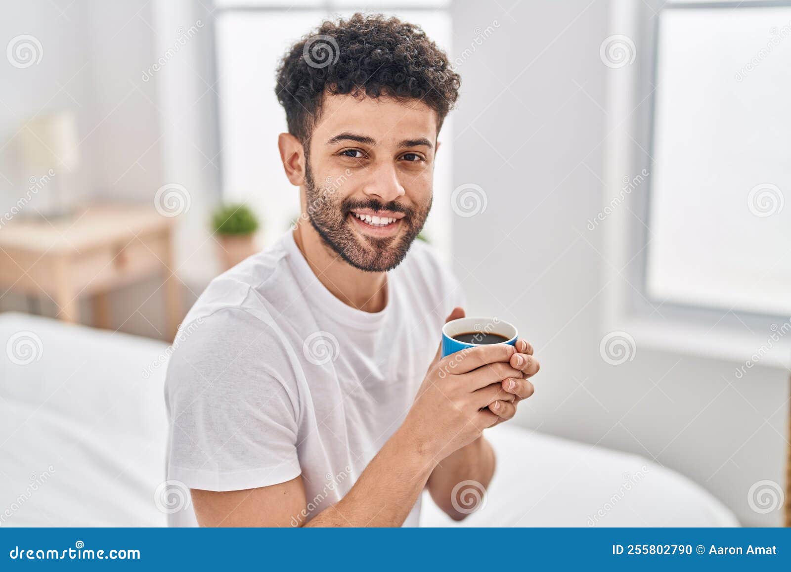 Young Arab Man Drinking Cup of Coffee Sitting on Bed at Bedroom Stock ...