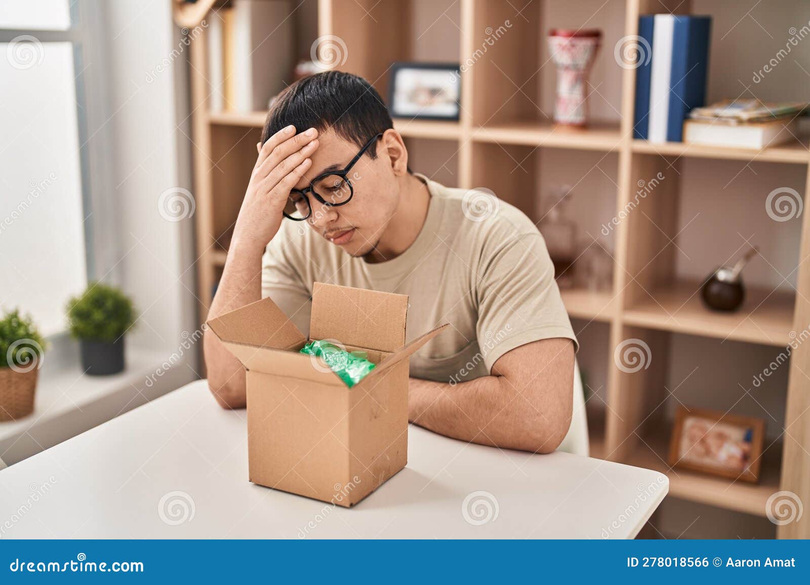 Young Arab Man with Open Gift in Cardboard Box Surprised with Hand on ...