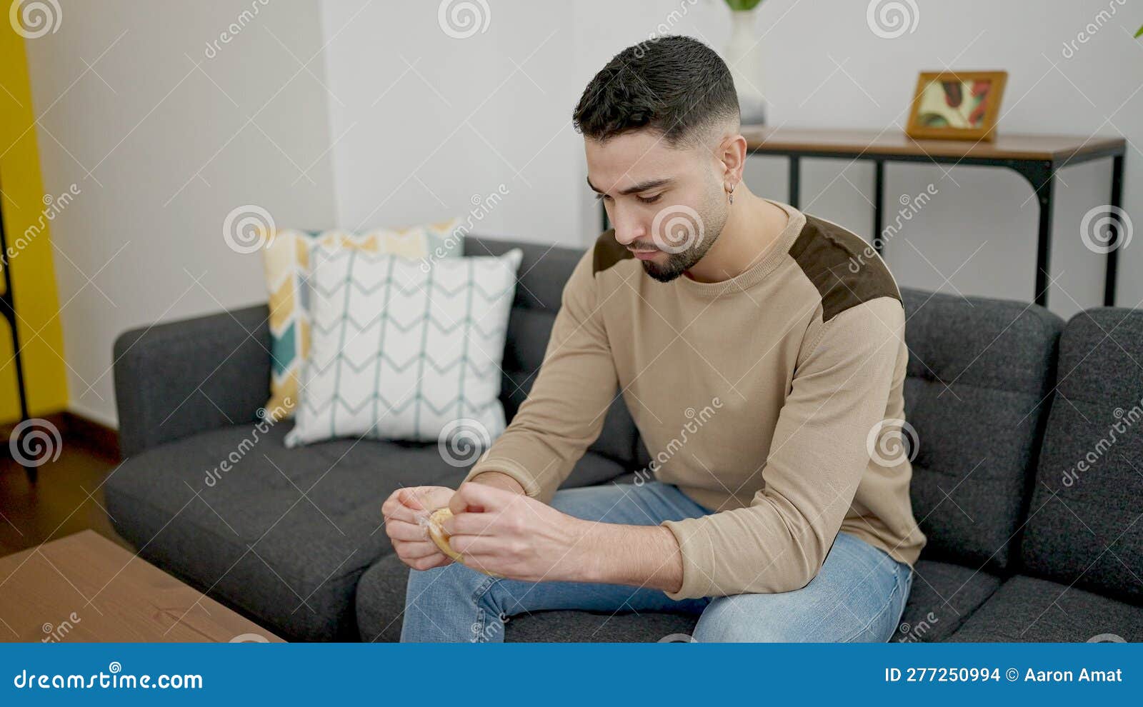 Young Arab Man Opening Plastic Wrap at Home Stock Photo - Image of ...