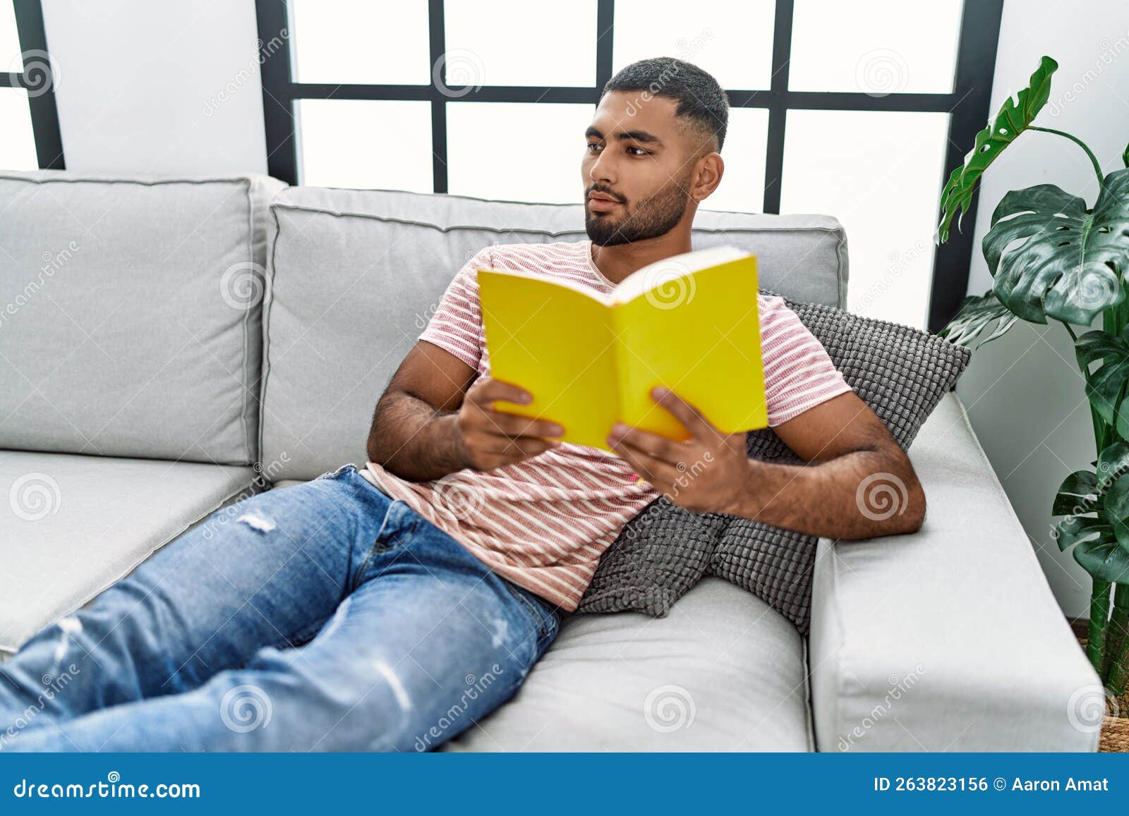 Young Arab Man Reading Book at Home Stock Photo - Image of smart ...