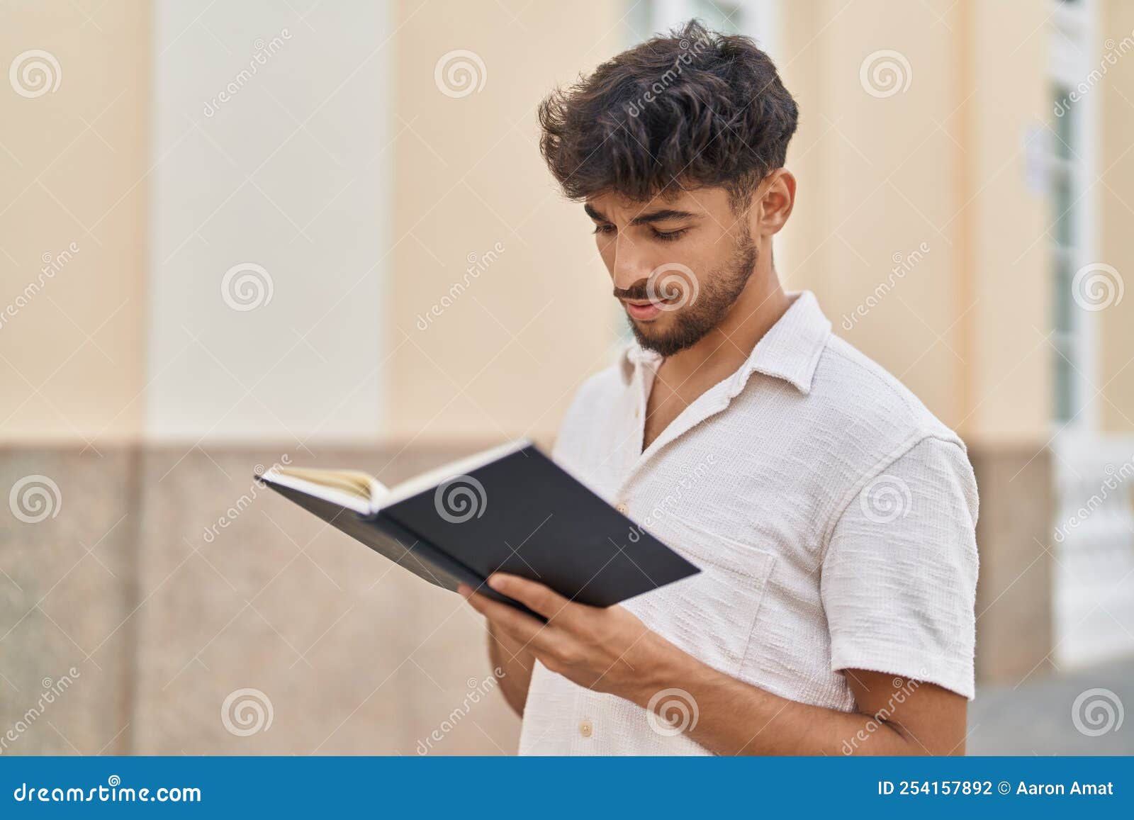 Young Arab Man Reading Book at Street Stock Photo - Image of knowledge ...