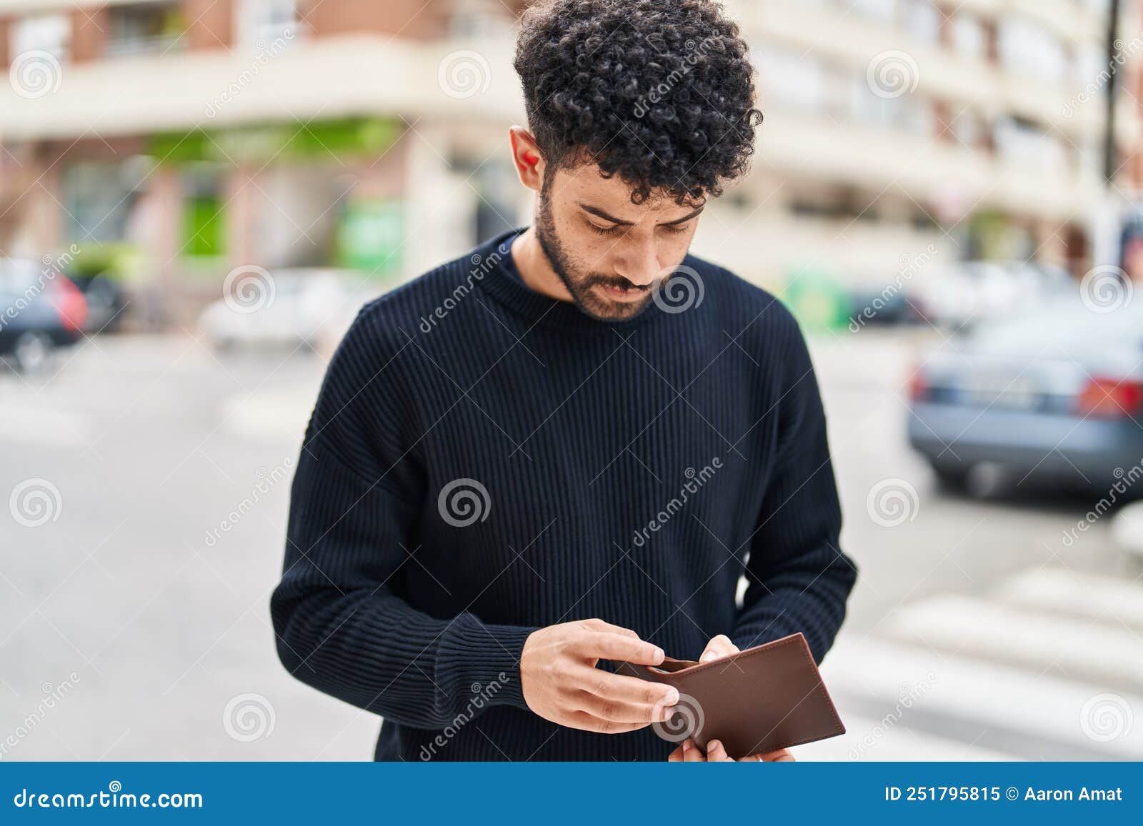 Young Arab Man with Relaxed Expression Counting Dollars at Street Stock ...