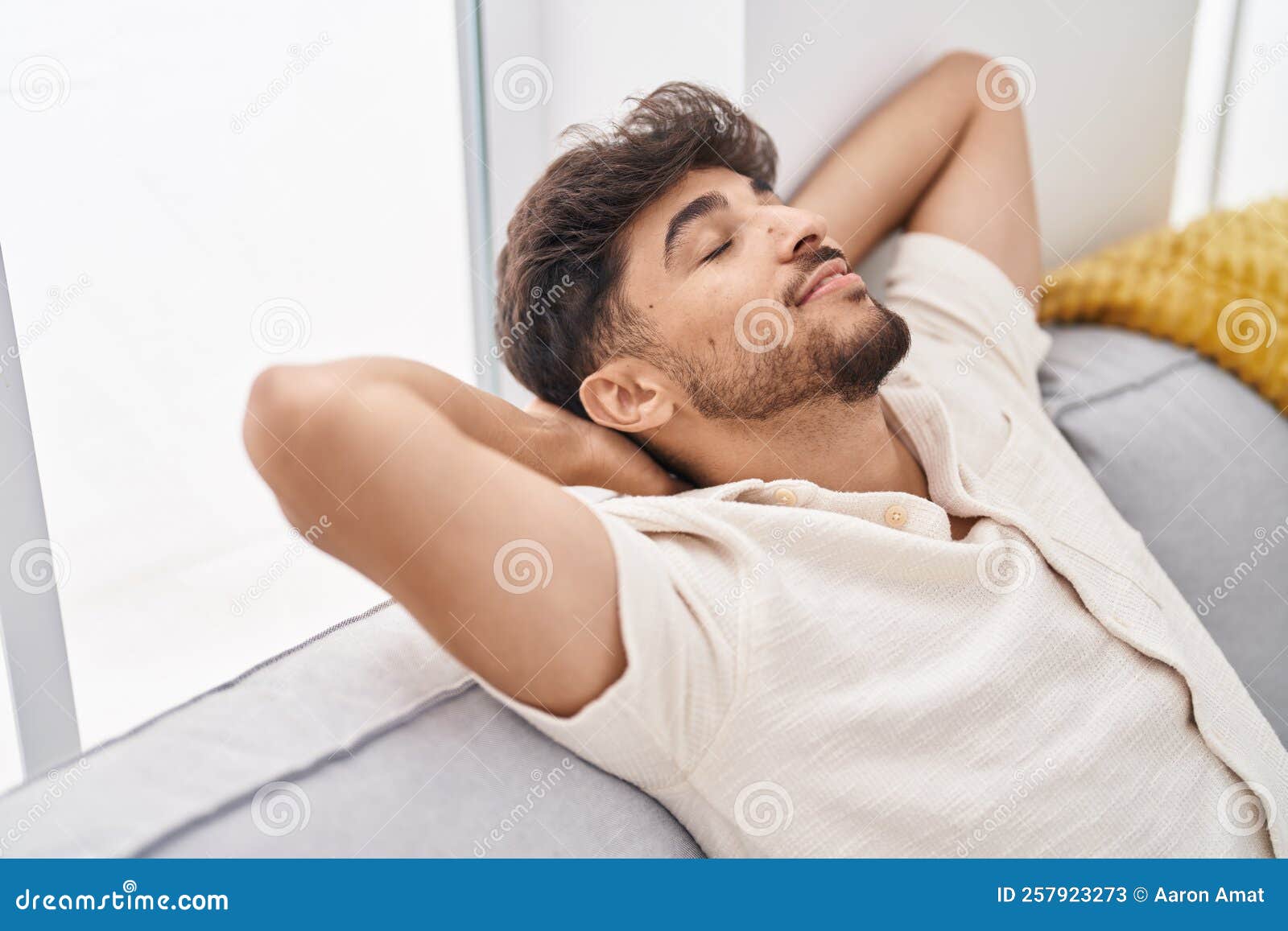 Young Arab Man Relaxed with Hands on Head Sitting on Sofa at Home Stock ...