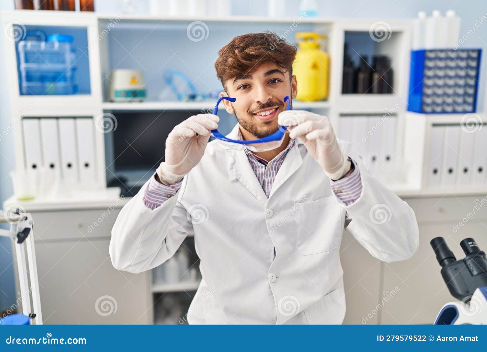 Young Arab Man Scientist Holding Security Glasses at Laboratory Stock ...