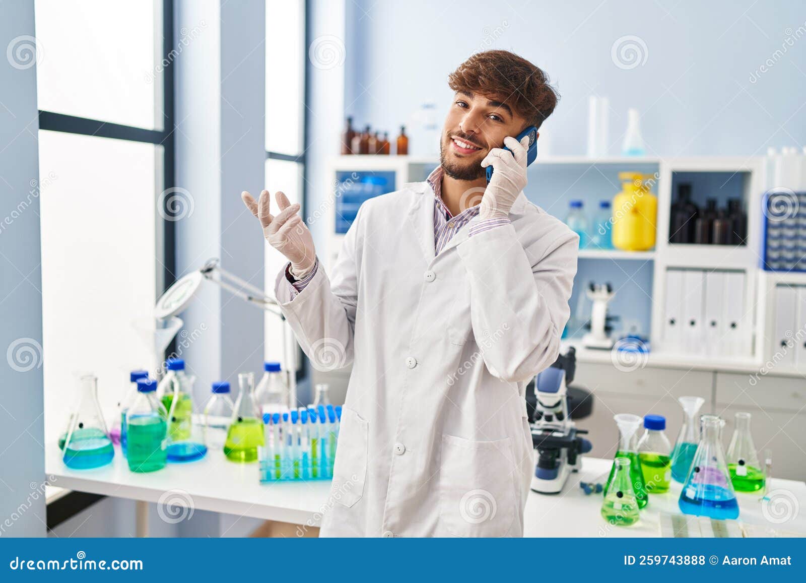 Young Arab Man Scientist Smiling Confident Talking on Smartphone at ...