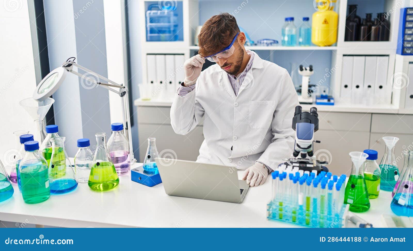 Young Arab Man Scientist Stressed Using Laptop Working at Laboratory ...