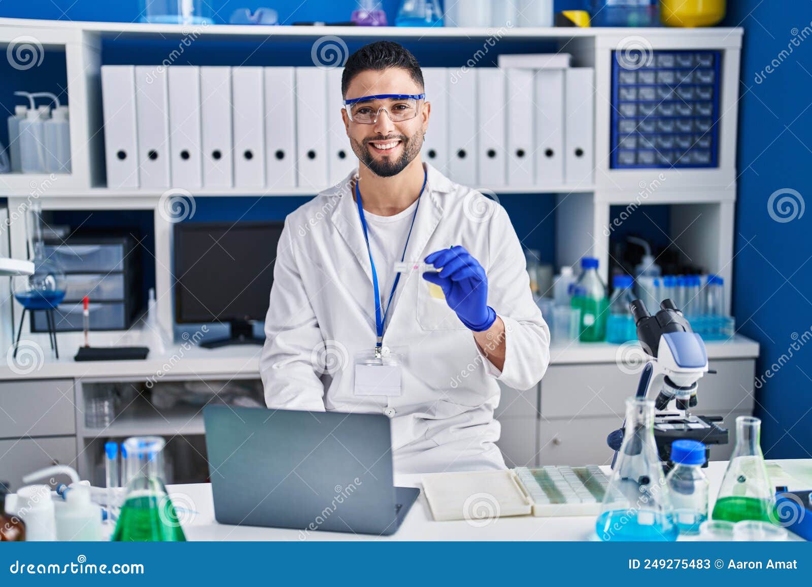 Young Arab Man Scientist Using Laptop Holding Sample at Laboratory ...