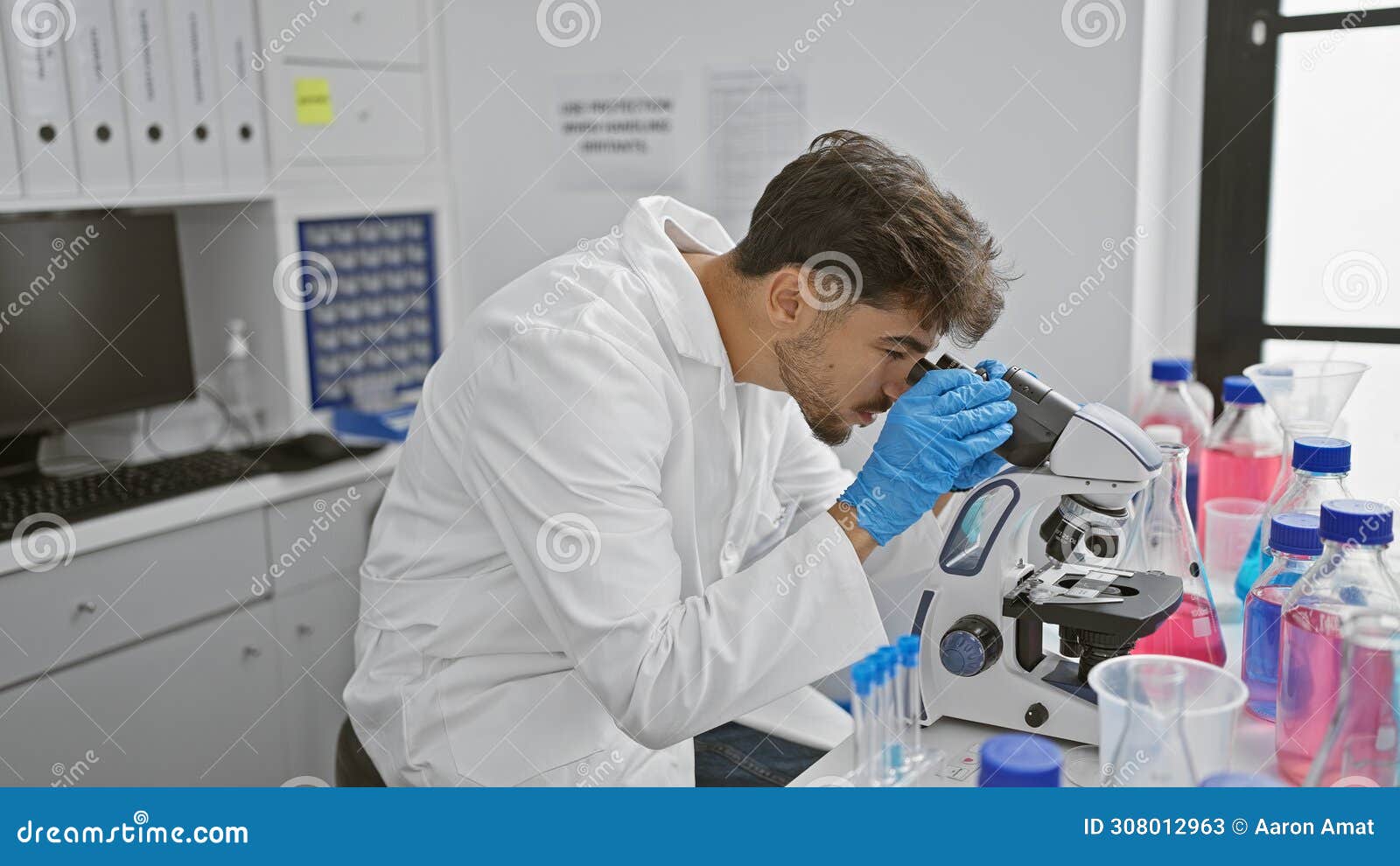 Young Arab Man Scientist Using Microscope at Laboratory Stock Image ...