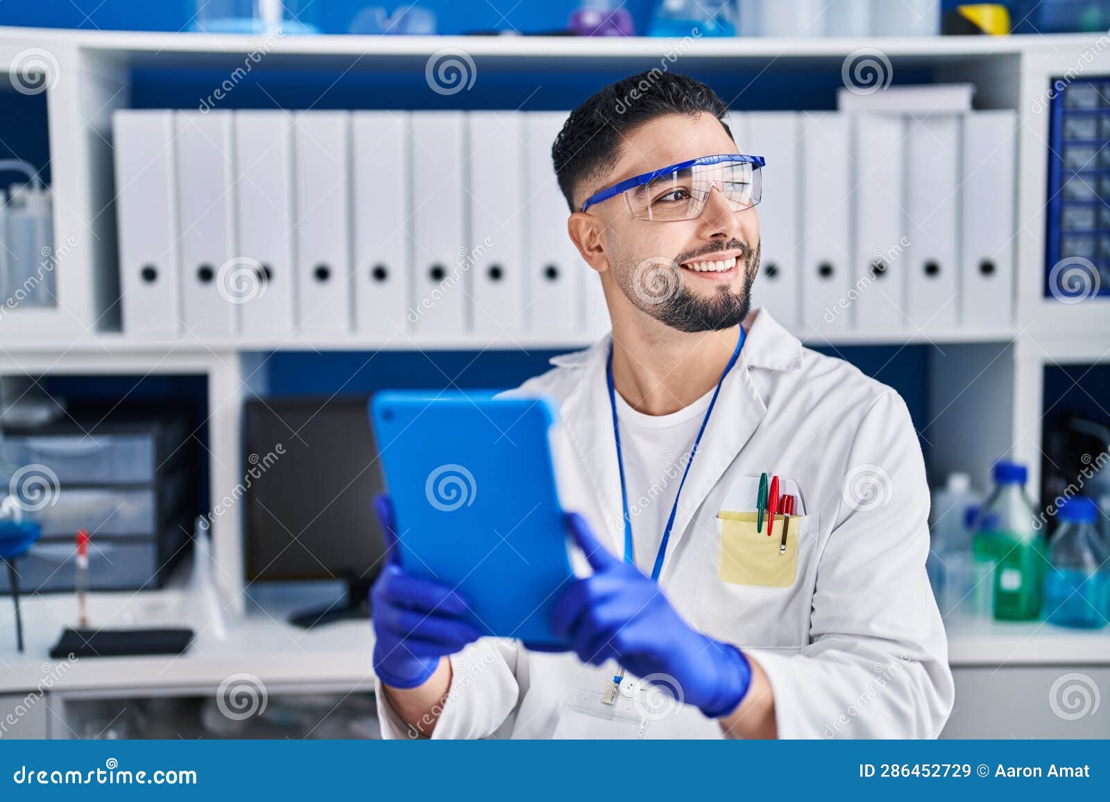 Young Arab Man Scientist Using Touchpad Working at Laboratory Stock ...