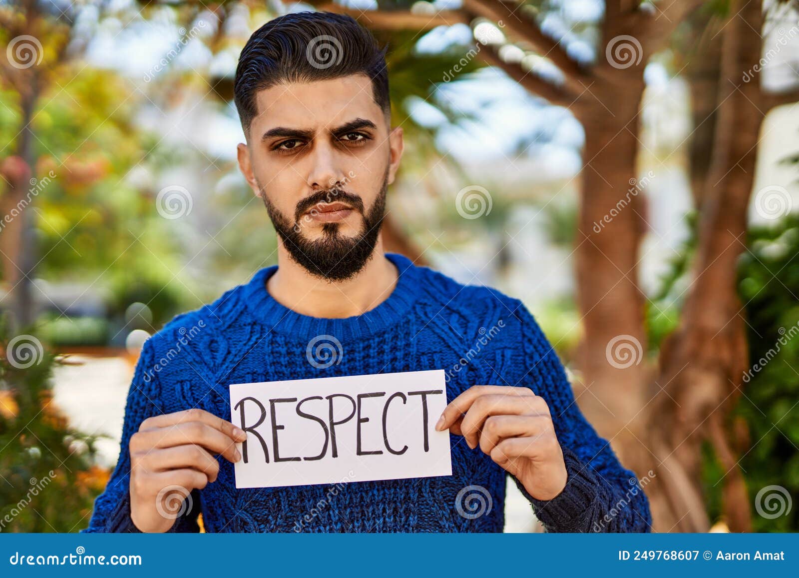 Young Arab Man Serious Holding Respect Banner at Park Stock Image ...