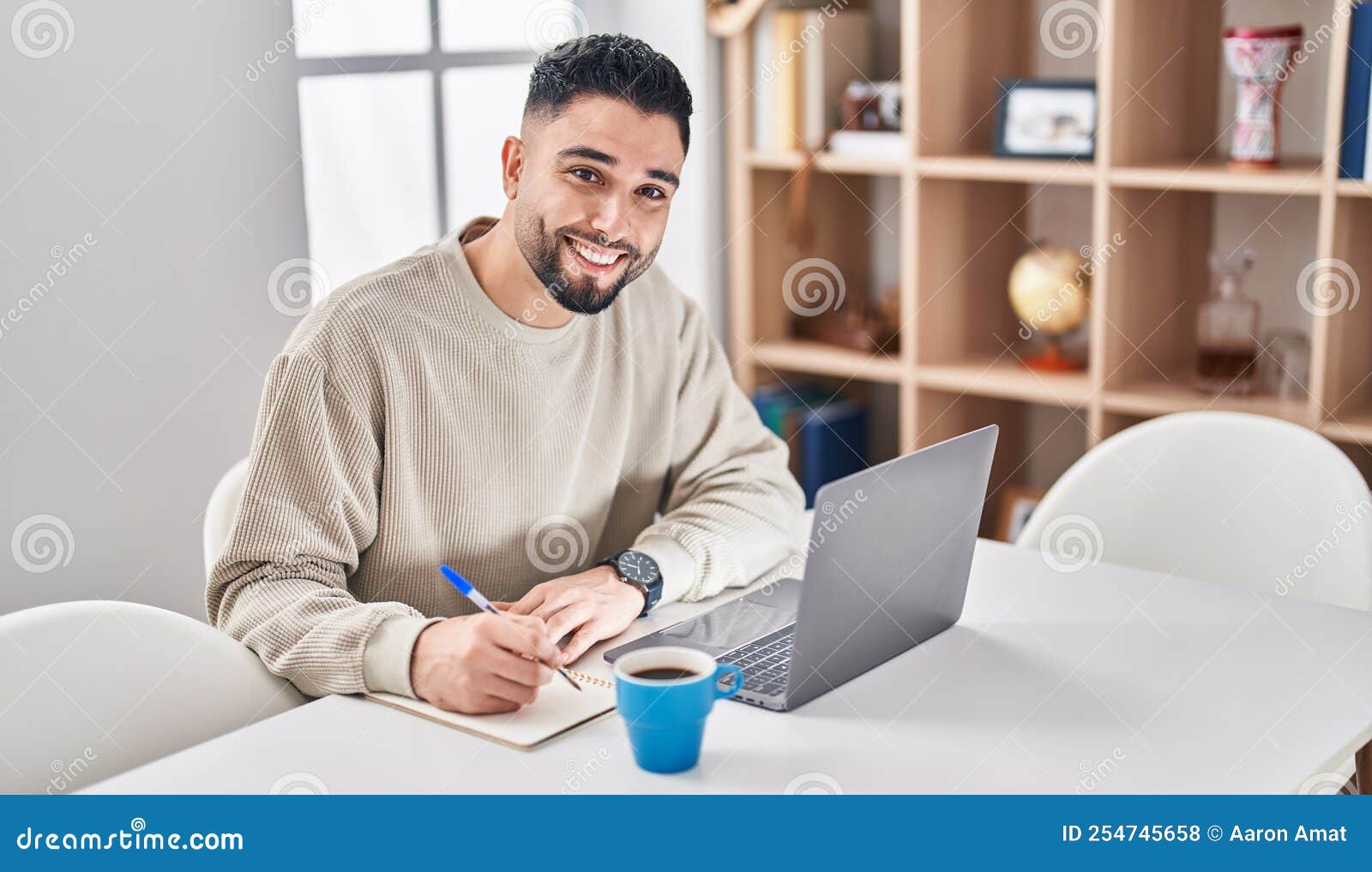 Young Arab Man Sitting on Table Studying at Home Stock Photo - Image of ...