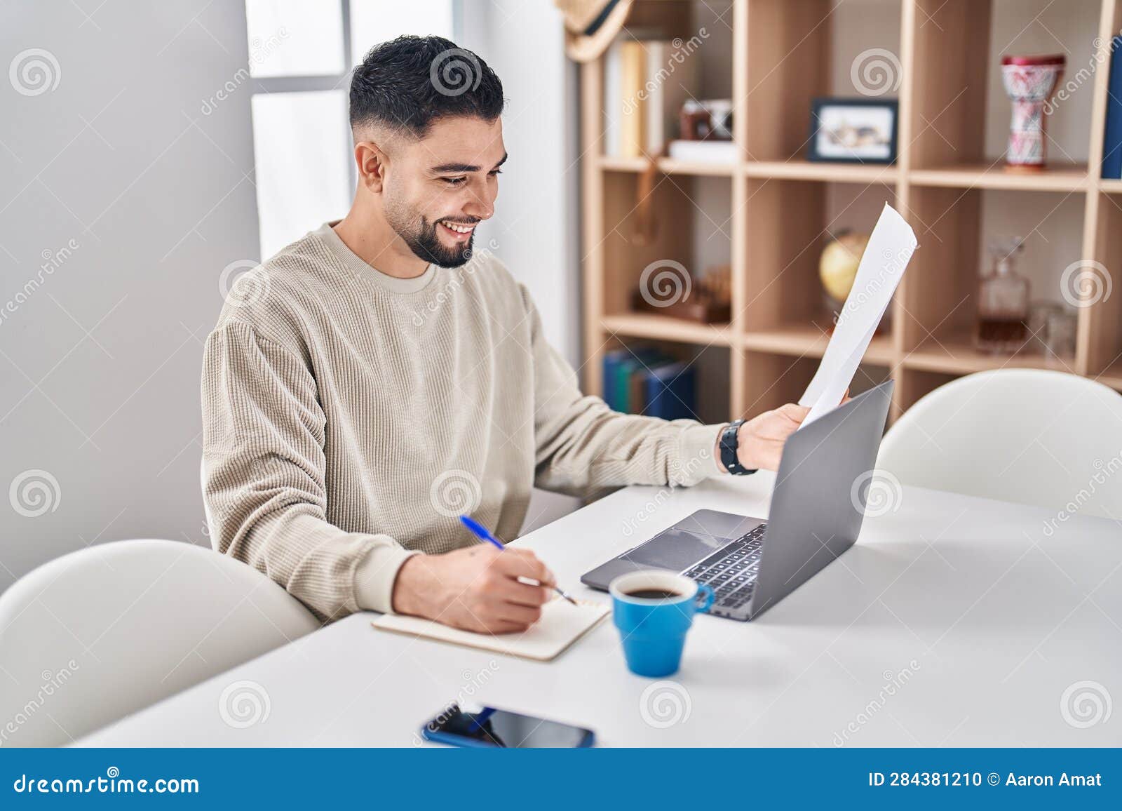 Young Arab Man Sitting on Table Studying at Home Stock Photo - Image of ...