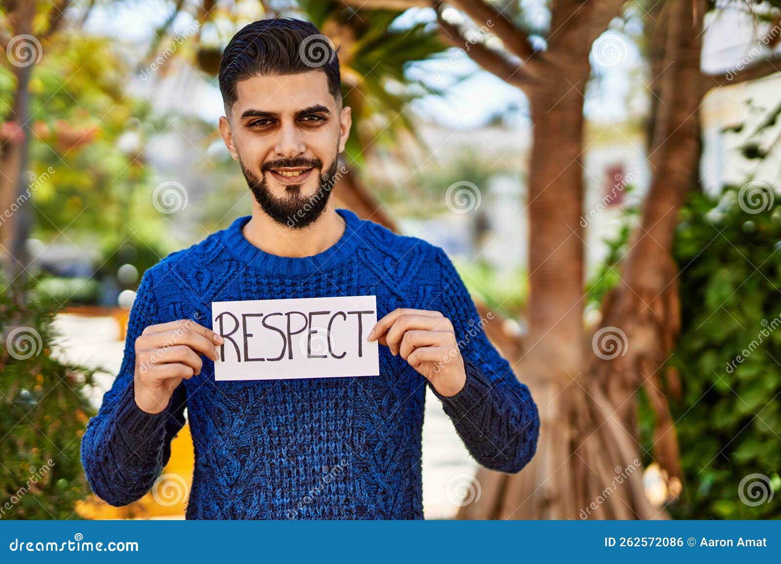 Young Arab Man Smiling Confident Holding Respect Banner at Park Stock ...