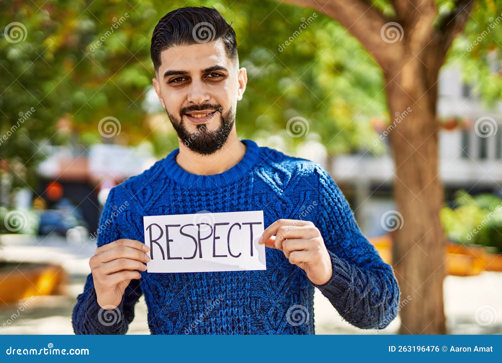 Young Arab Man Smiling Confident Holding Respect Banner at Park Stock ...