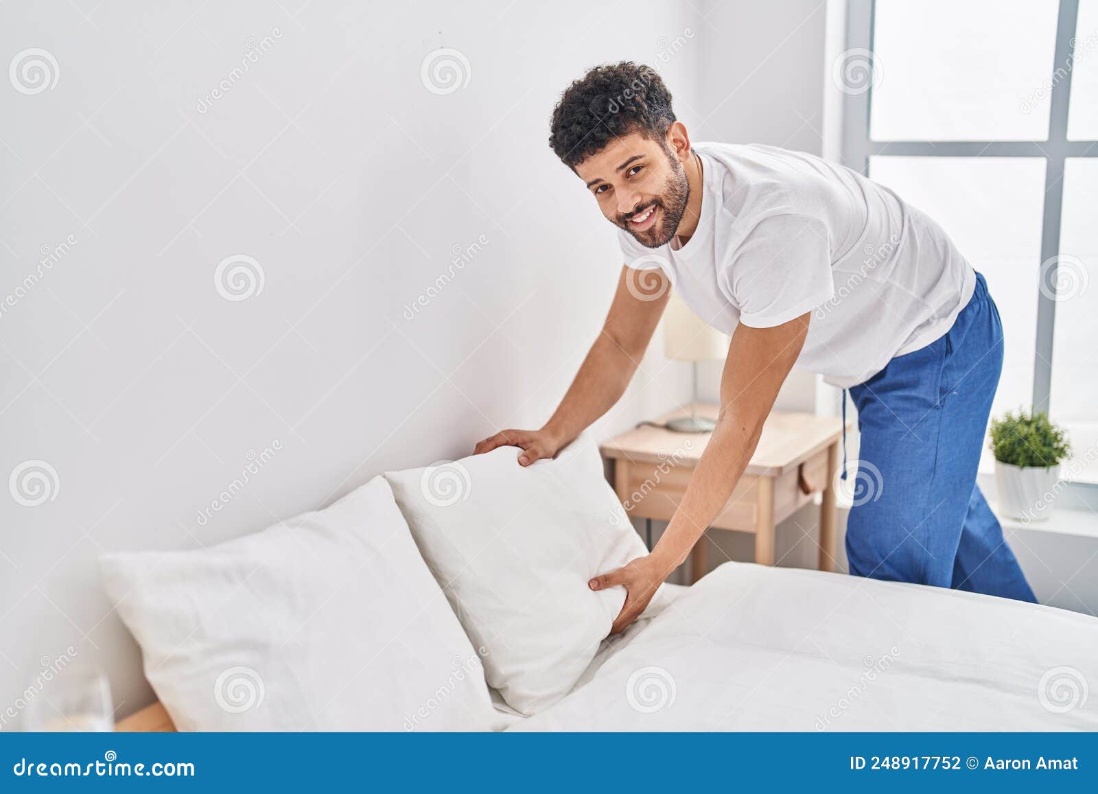 Young Arab Man Smiling Confident Making Bed at Bedroom Stock Photo ...