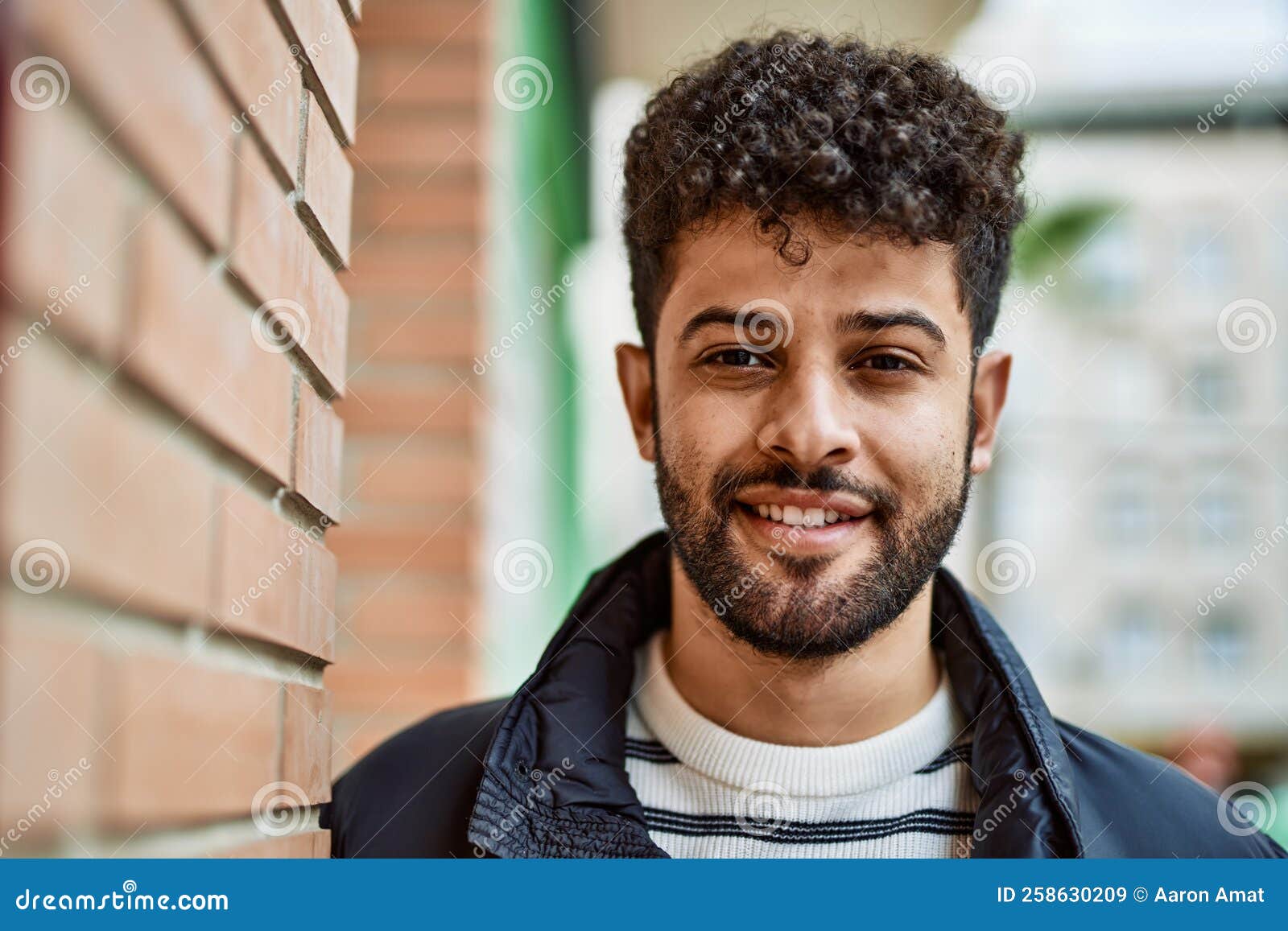 Young Arab Man Smiling Leaning on Bricks Wall Stock Image - Image of ...