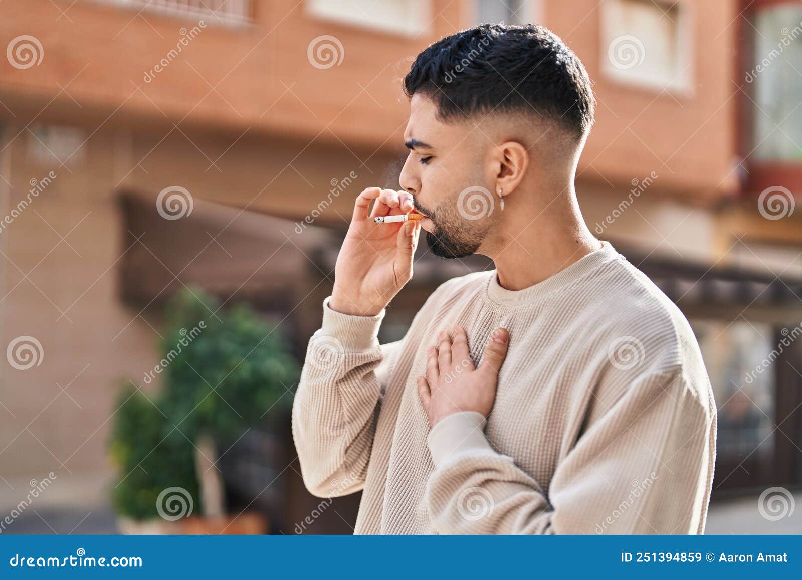 Young Arab Man Smoking with Relaxed Expression at Street Stock Image ...