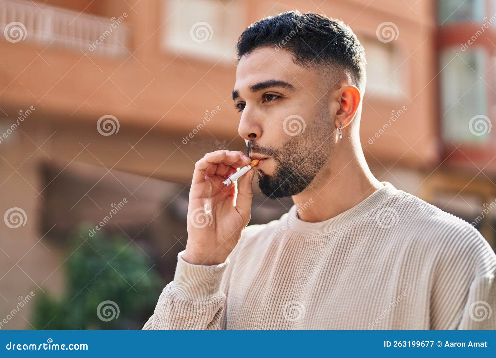 Young Arab Man Smoking with Relaxed Expression at Street Stock Image ...