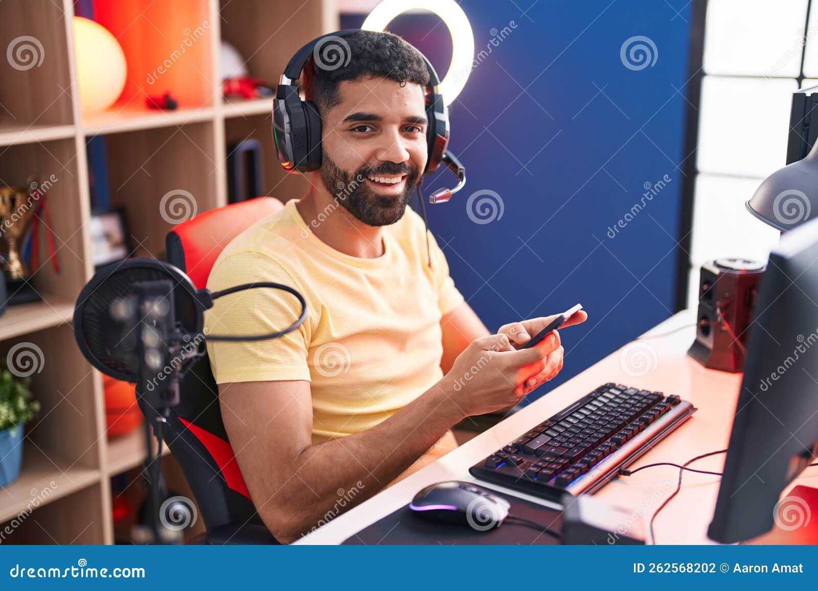 Young Arab Man Streamer Using Computer and Smartphone at Gaming Room ...