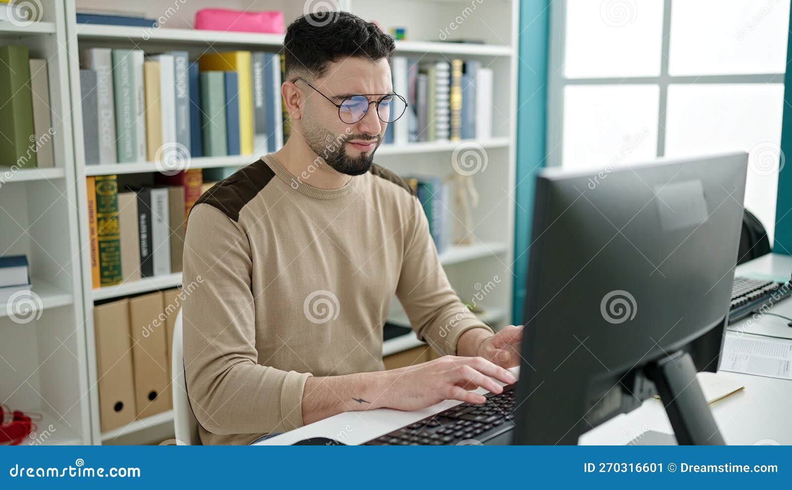 Young Arab Man Student Using Computer Studying at University Classroom ...
