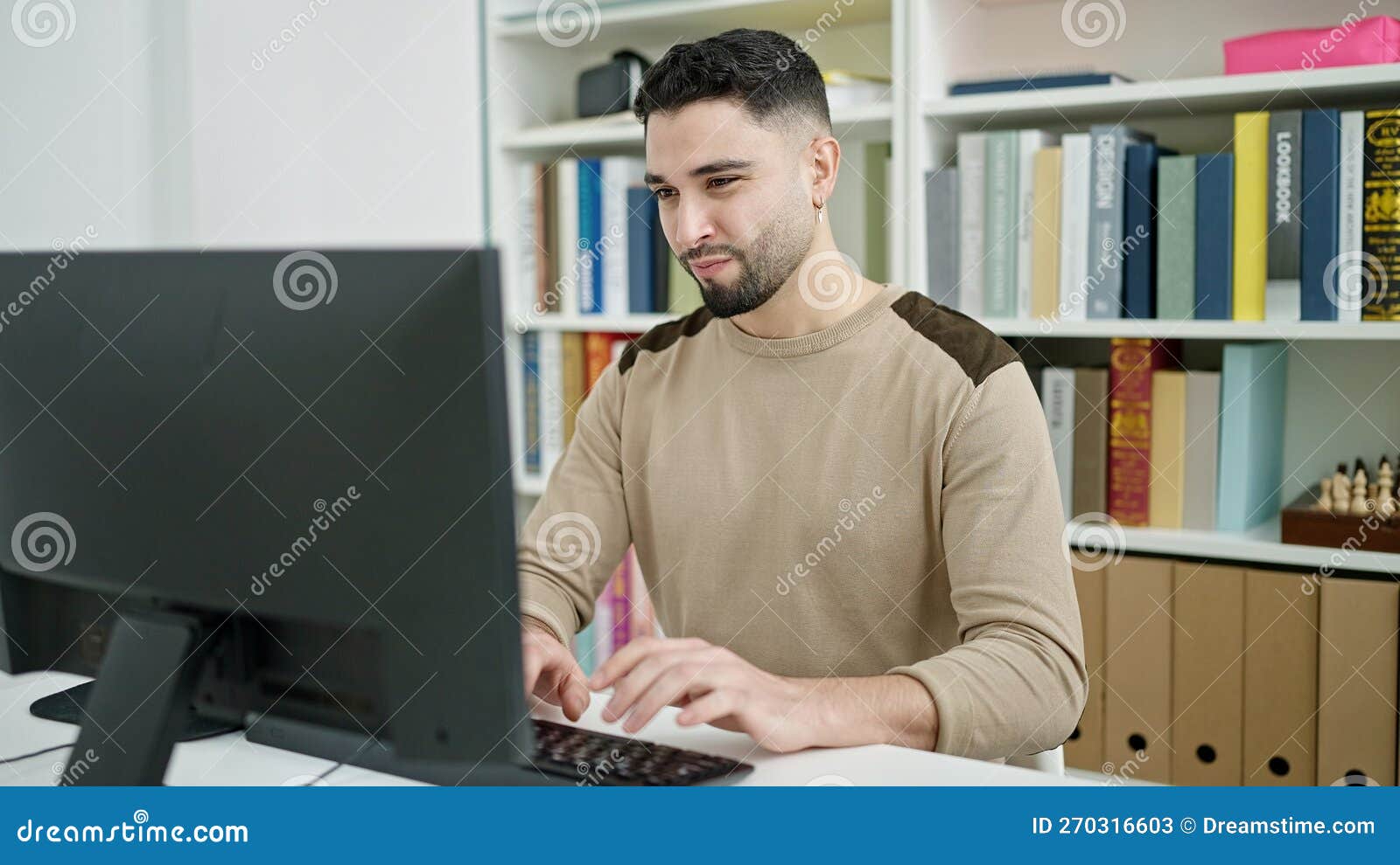 Young Arab Man Student Using Computer Studying at University Classroom ...