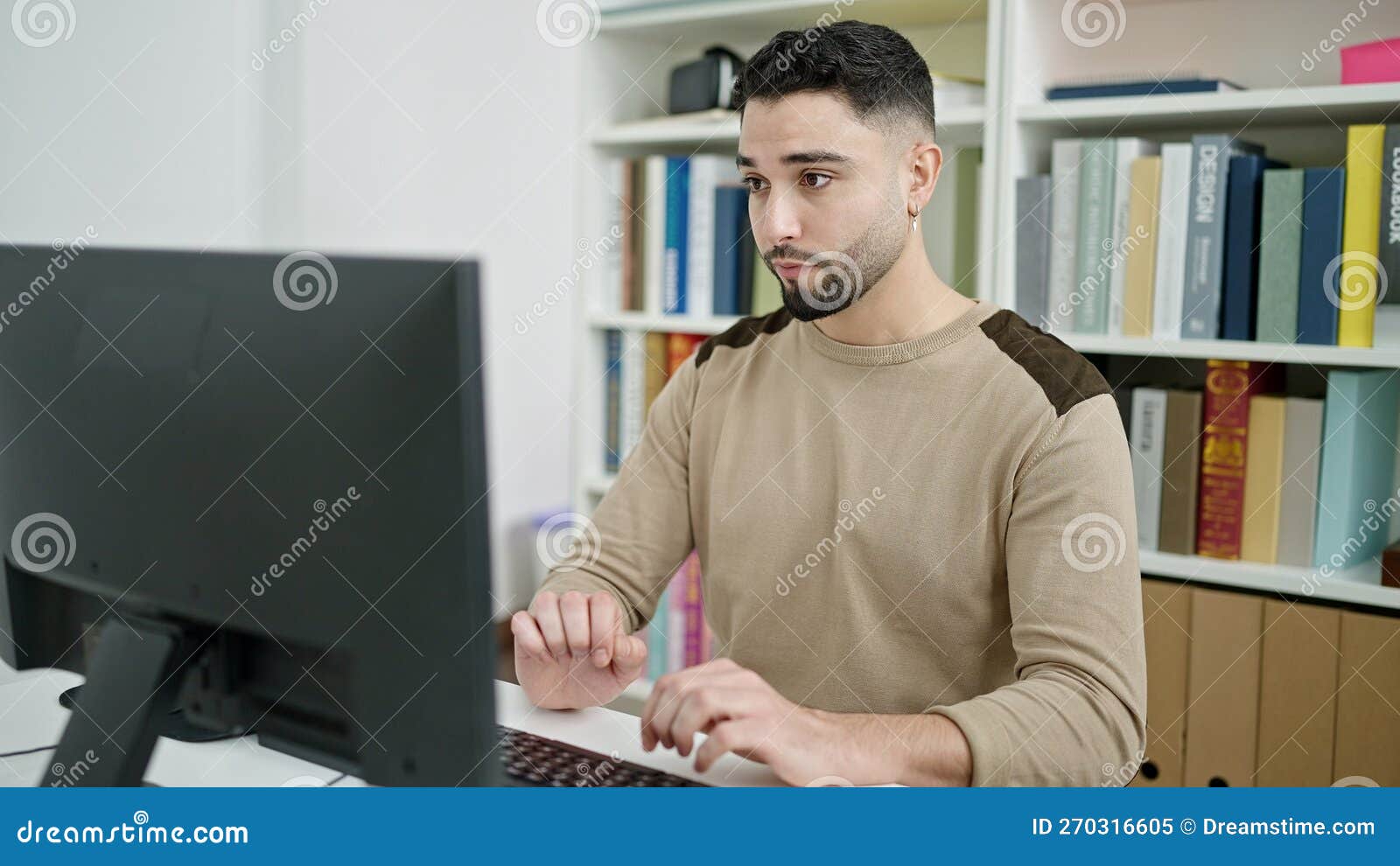 Young Arab Man Student Using Computer Studying at University Classroom ...