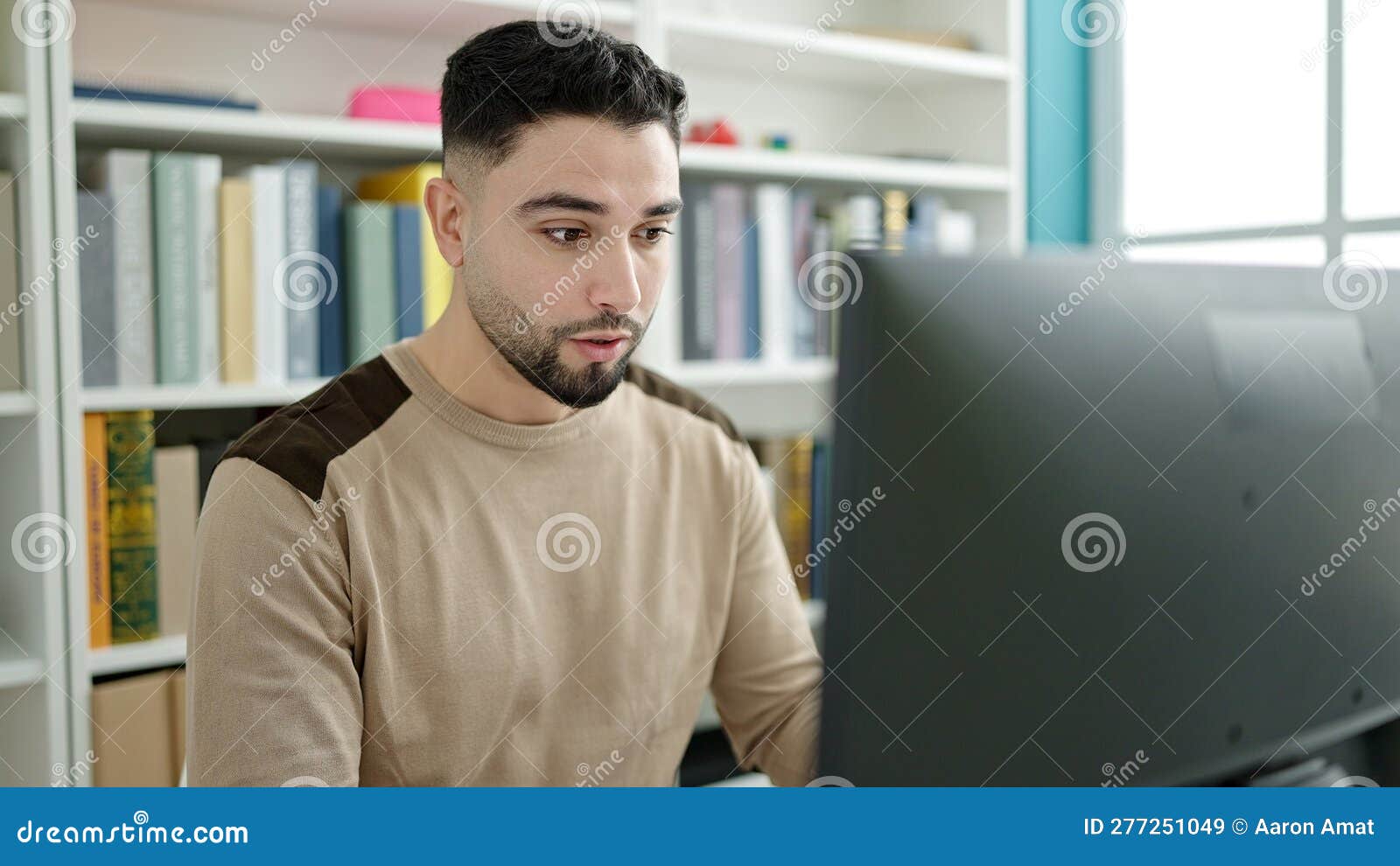 Young Arab Man Student Using Computer Studying at University Classroom ...