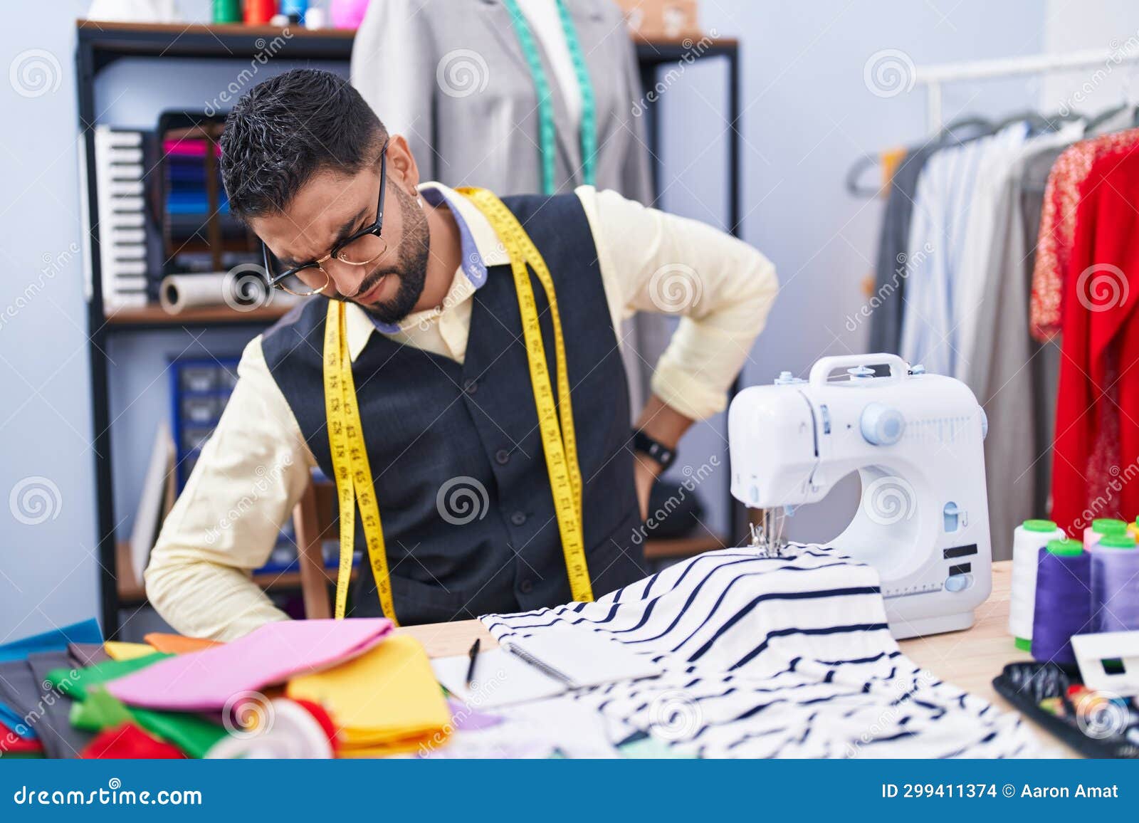 Young Arab Man Tailor Stressed Using Sewing Machine at Clothing Factory ...