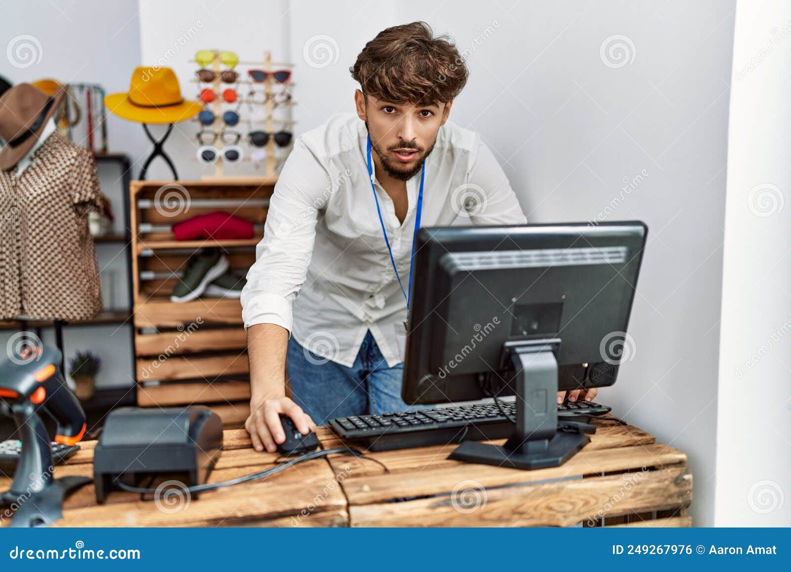 Young Arab Man Using Computer Working at Clothing Store Stock Photo ...