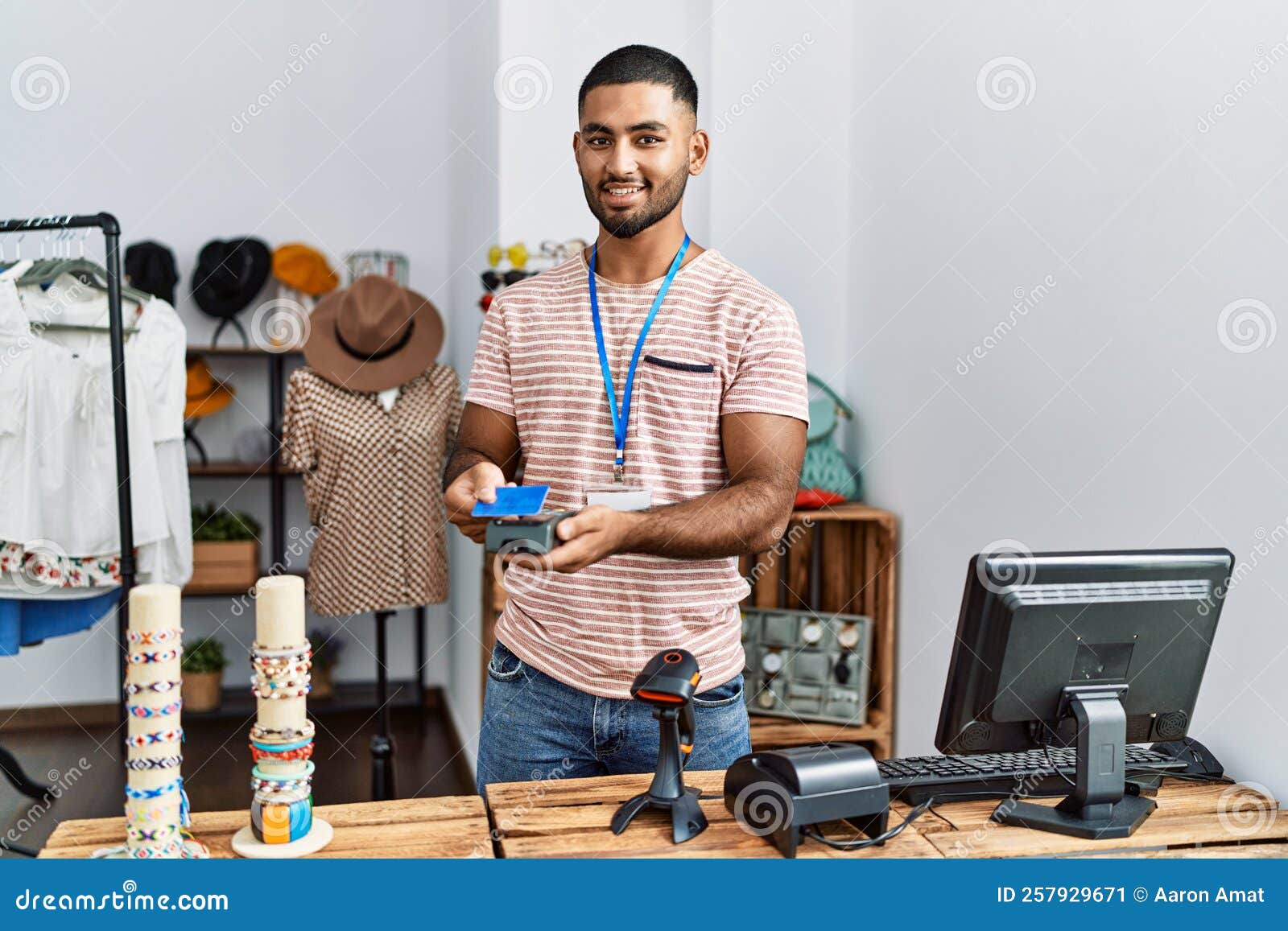 Young Arab Man Using Data Phone and Credit Card Working at Clothing ...